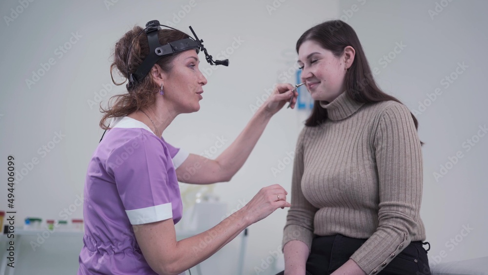 Otolaryngology concept. Positive woman otorhinolaryngologist checking ...