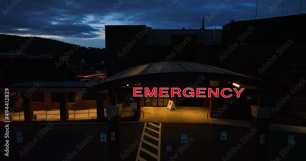 Emergency room sign, entrance at hospital building. Rising aerial at ...