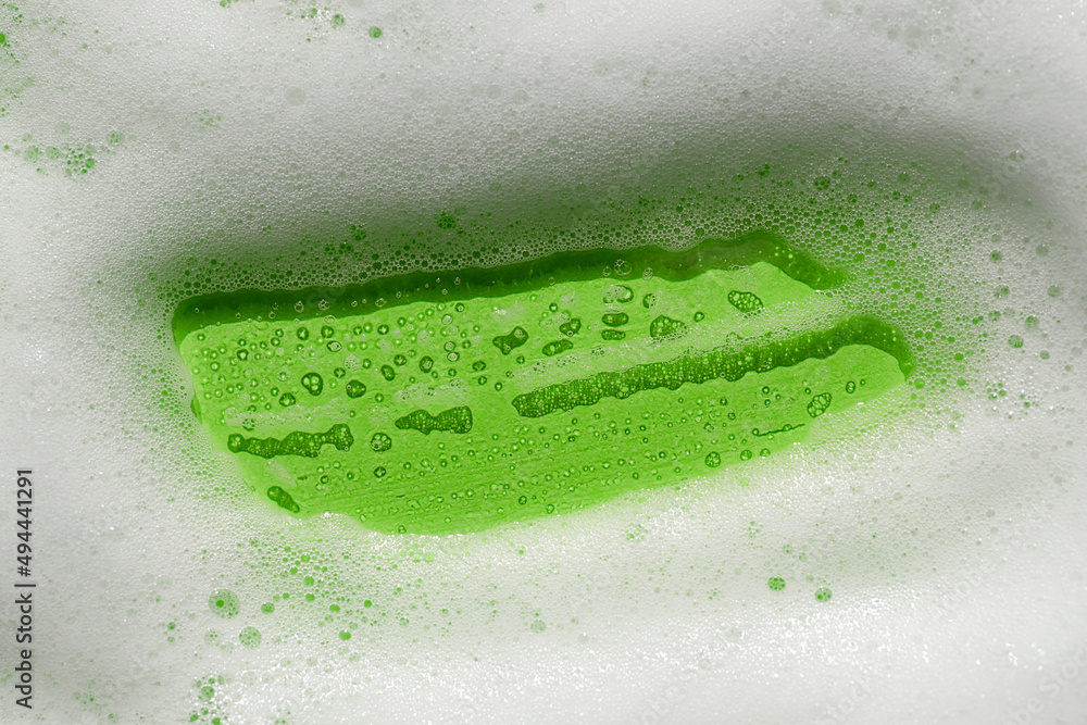 Foam on a green background. Soapy liquid texture with bubbles. Natural ...