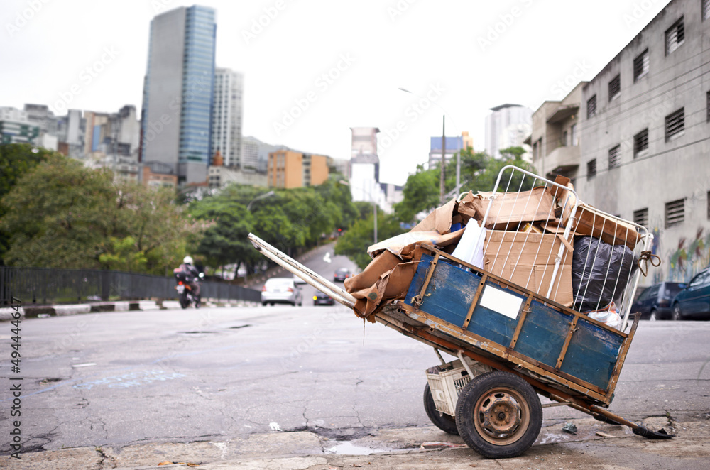 Transporting the trash. Shot of a cart full of garbage in the street of ...