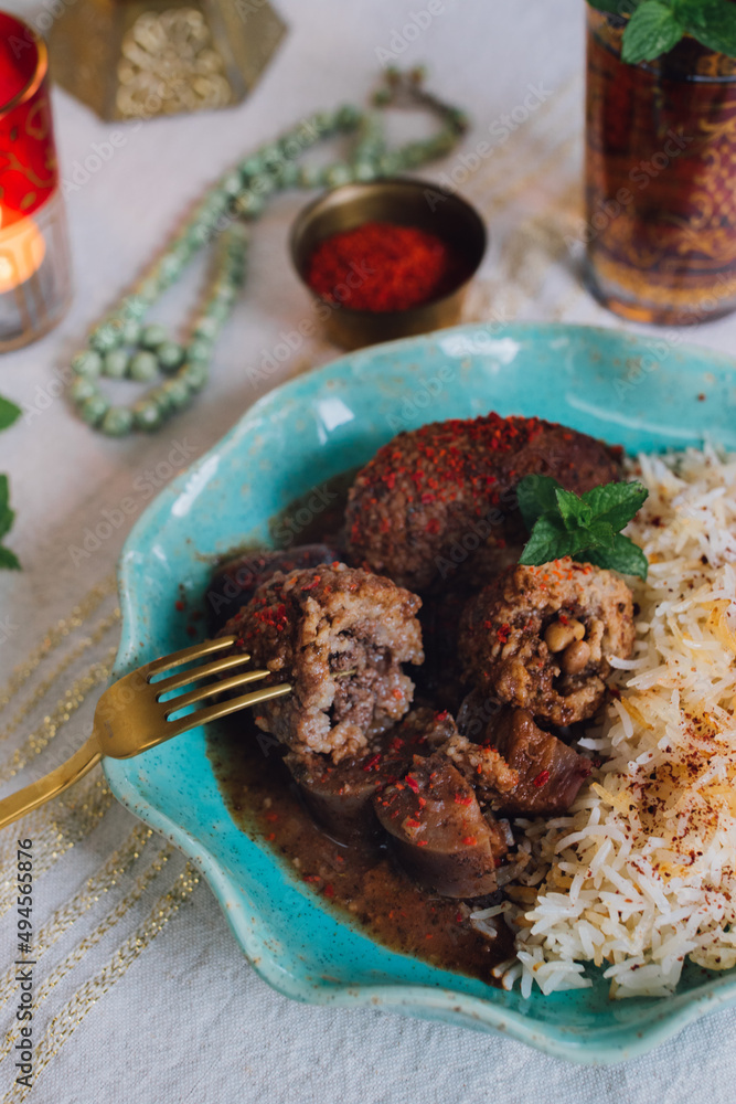 fork piercing meatball: Kibbe Summaqiyeh, kibbeh in sumac stock ...