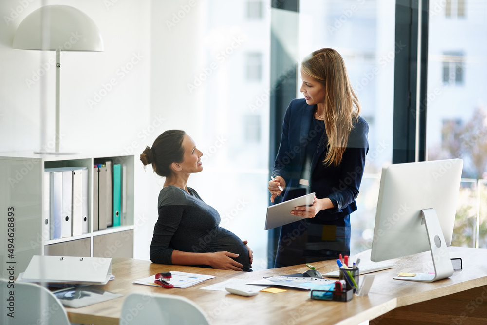 This office is positively glowing. Shot of a pregnant businesswoman and ...