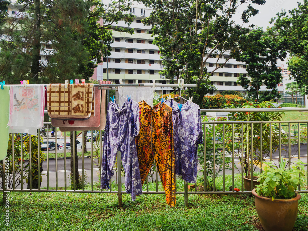 Laundry hanging on bamboo poles, out to dry in the sun, in a quiet ...