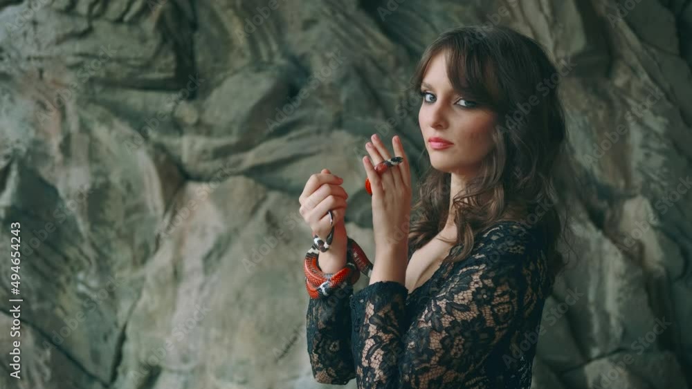 Portrait close-up female hands holding aspred red royal milk snake ...