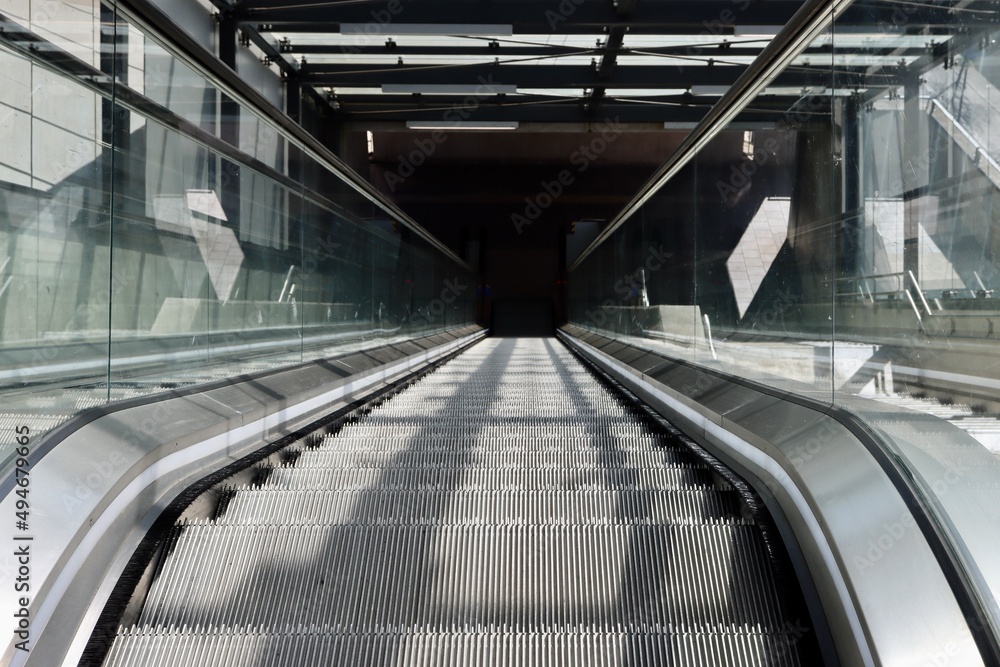 Modern moving escalator with motion blur inside a modern railway ...