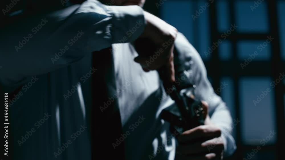 Police detective checking if his gun is charged, putting weapon into ...