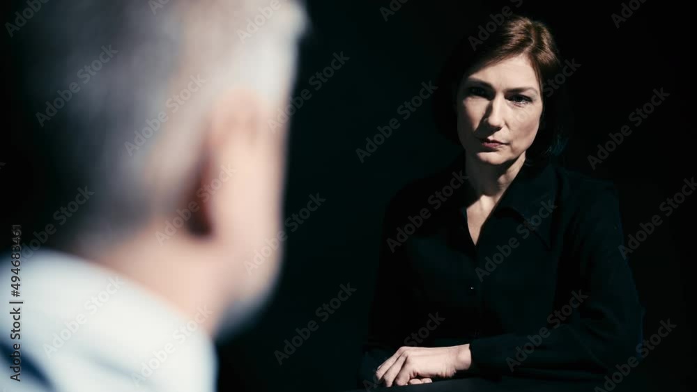 Police interrogation scene, detective showing photos of crime scene to ...