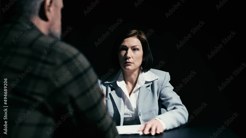 Female police detective questioning male suspect in custody ...