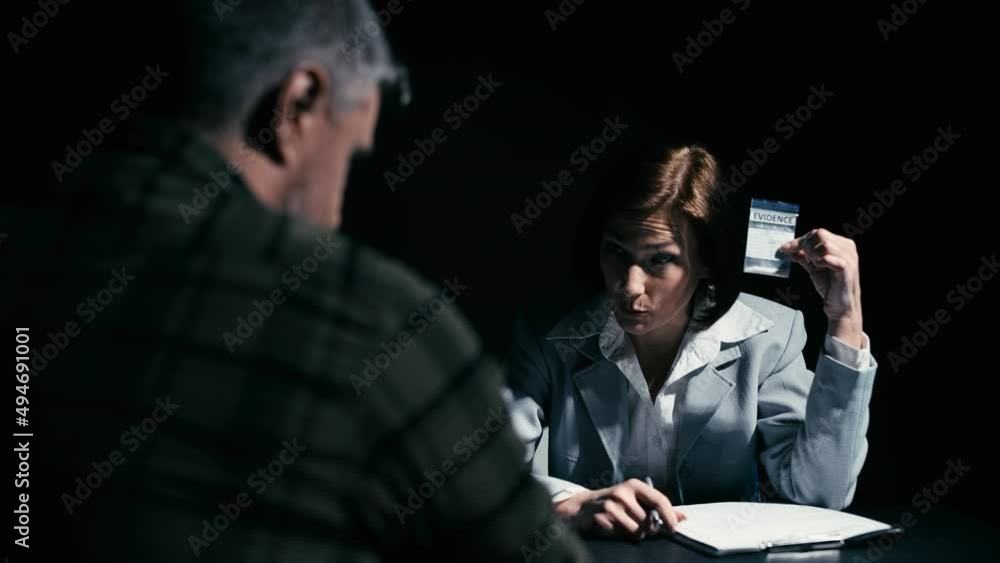 Female detective showing evidence bag with illegal substance to ...