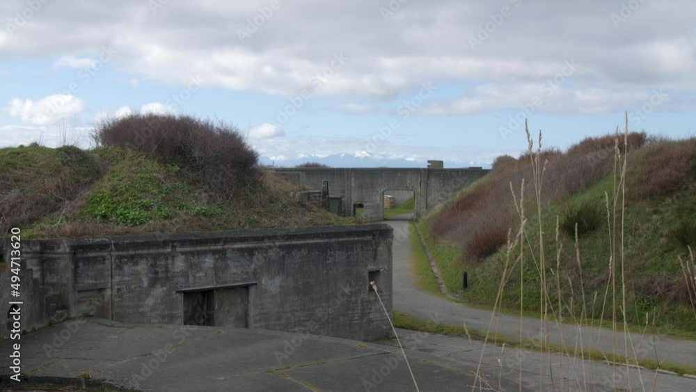 Wide establishing sliding shot of Fort Casey's abandoned military ...