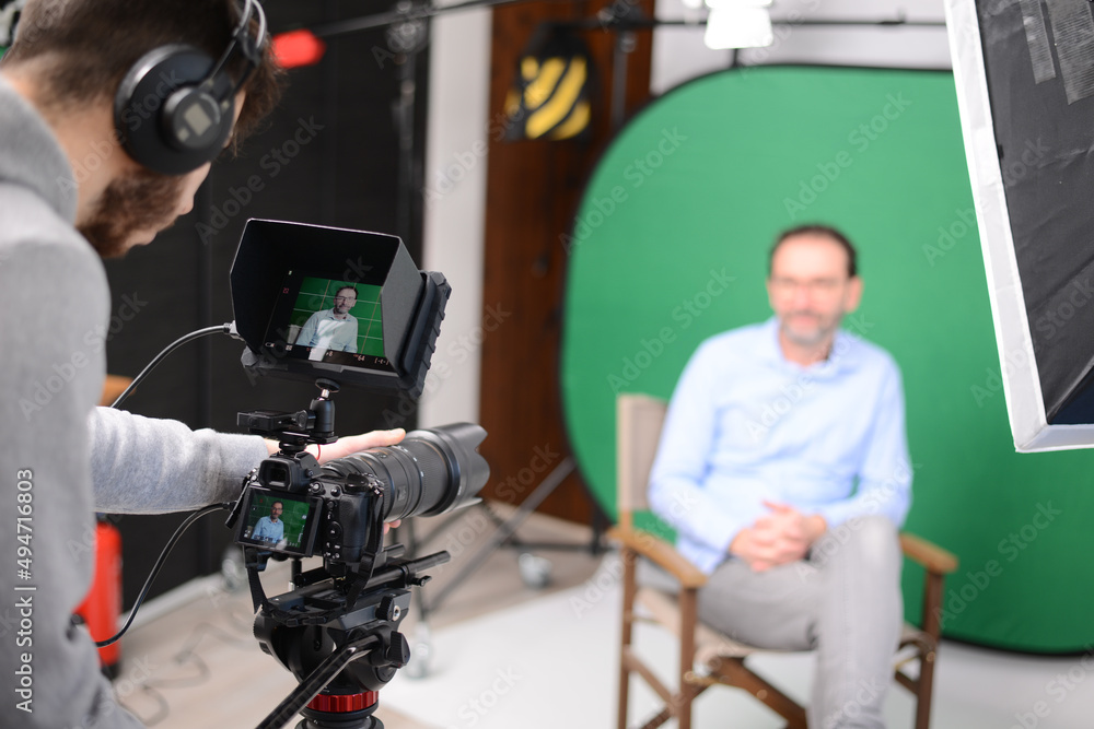 young man video camera operator making interview in professionnal ...