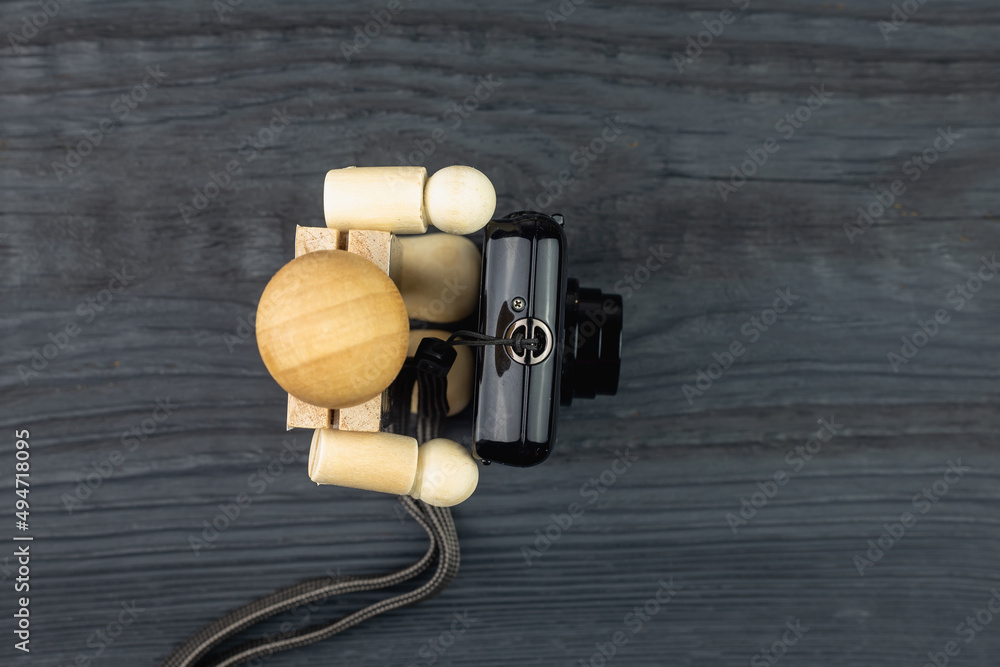 Photographer's wooden figure. Concept: photographer takes pictures with ...