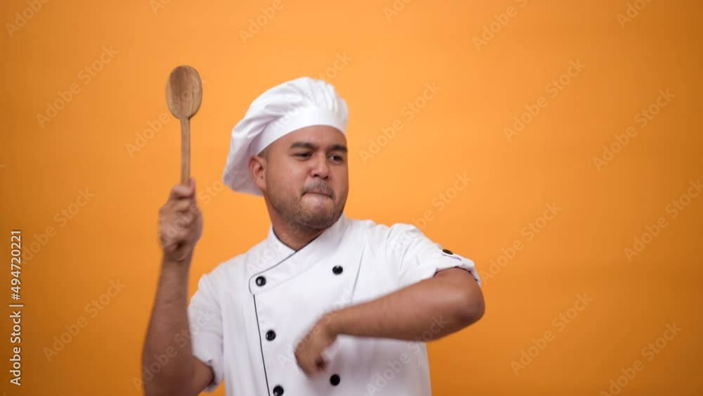 Portrait happy funny man chef holding kitchen utensils dancing isolated ...