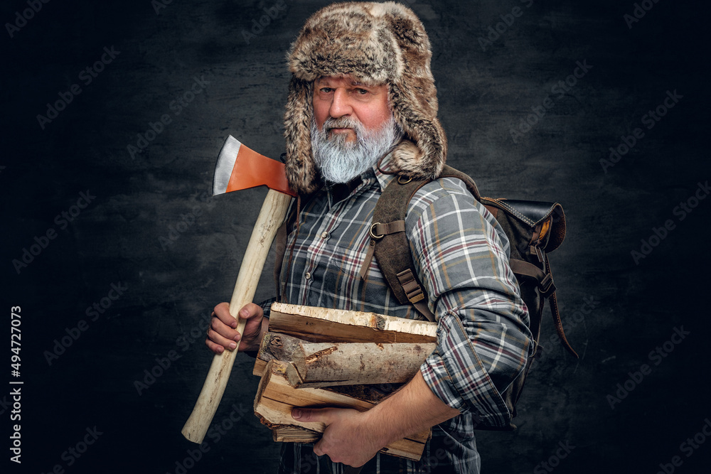 Old man woodman holding hatchet and stack of lumber Stock Photo | Adobe ...