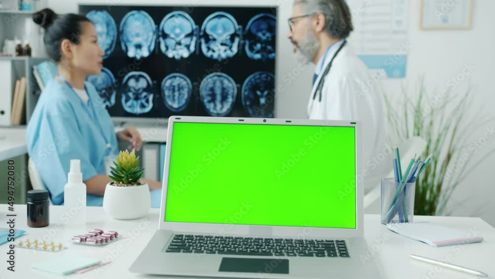 Chroma key green screen laptop with doctor and nurse in uniform ...