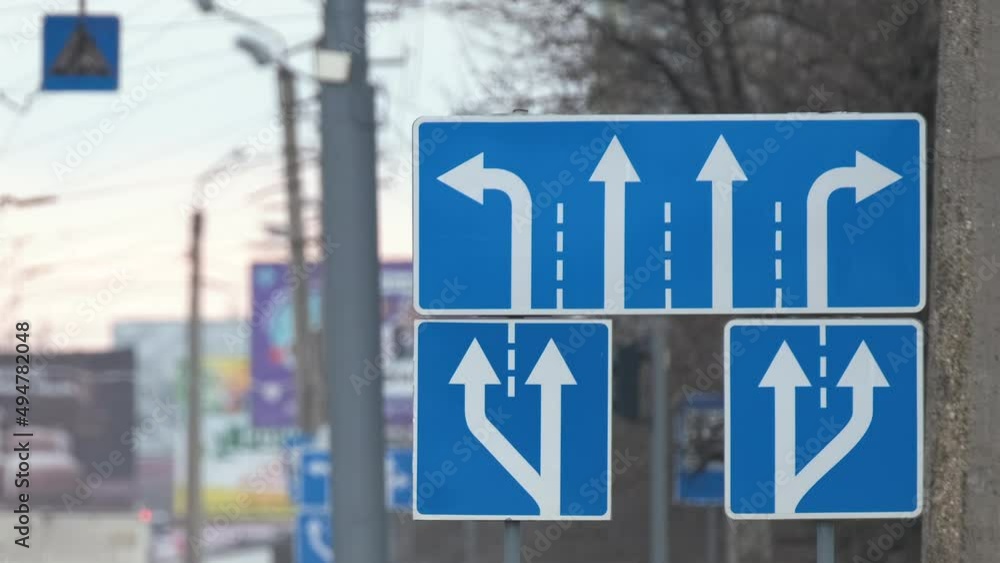 Traffic sign pointing multiple road lanes direction on city street ...
