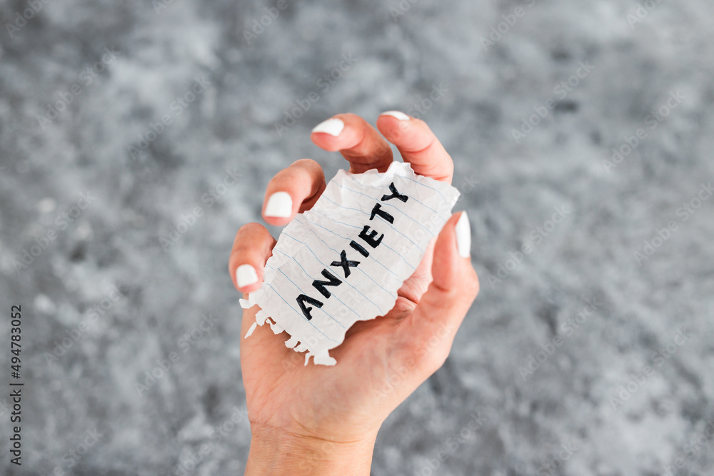 hand holding Anxiety text on scrunched up piece of paper, mental health ...