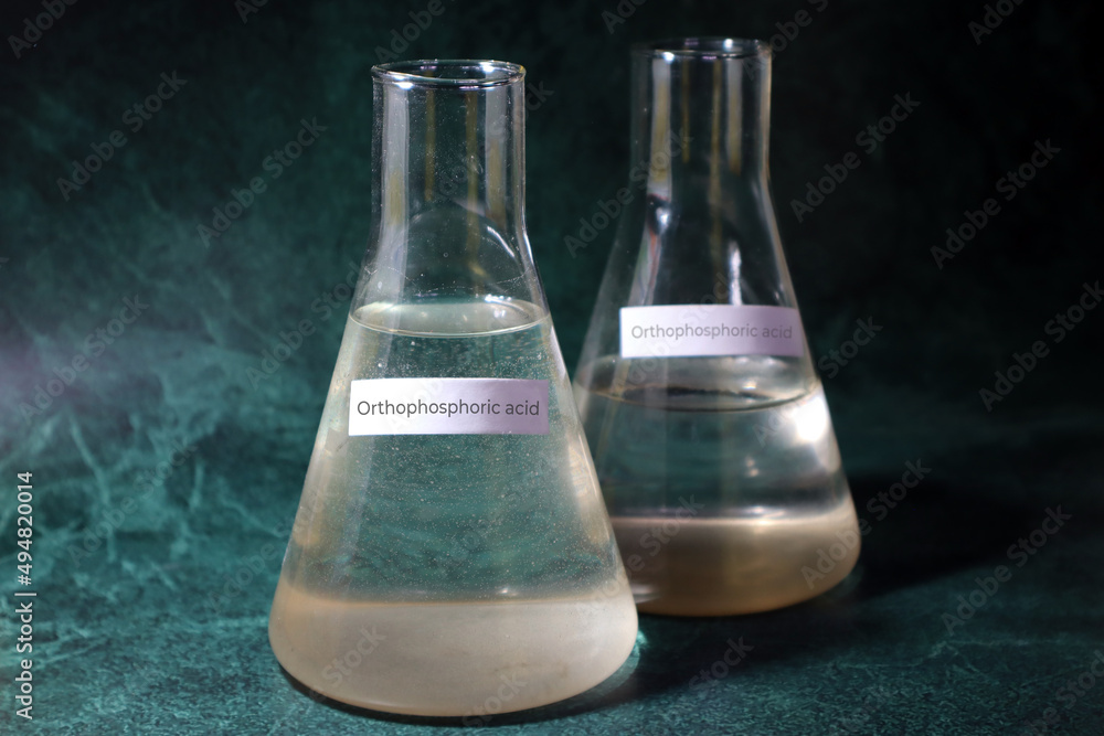 Phosphoric acid in flasks on a green background. H3PO4 Stock Photo ...