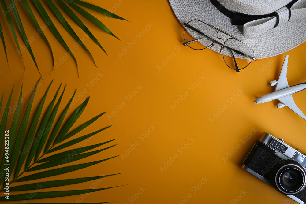 Traveler accessories on yellow background with palm leaf, camera and ...