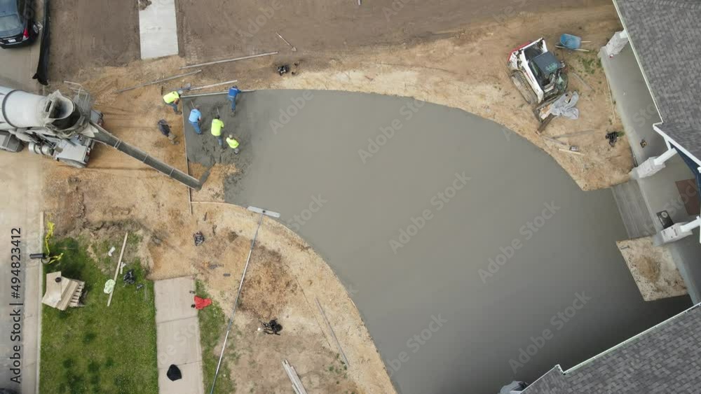 Birds eye view of concrete being poured to complete a new driveway ...