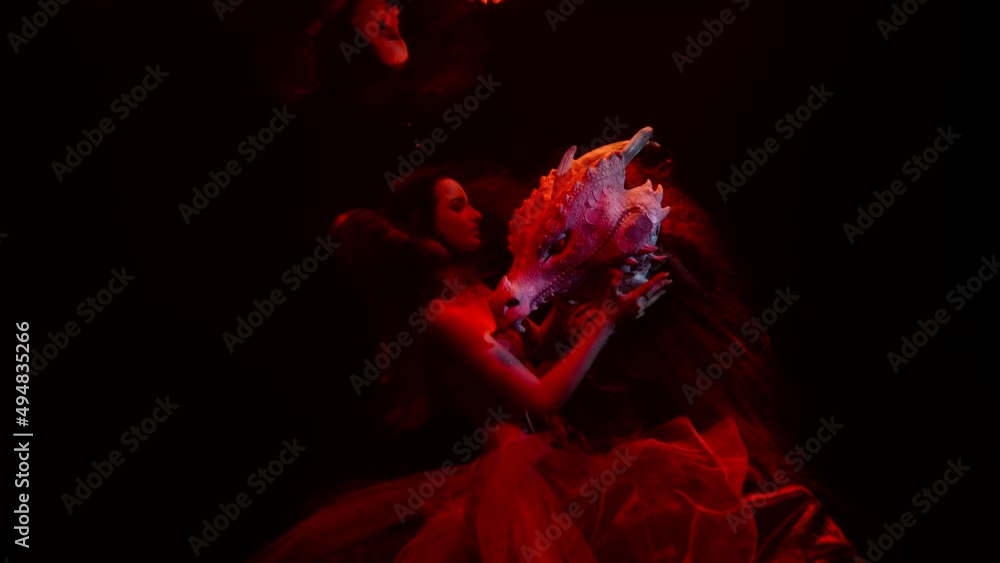 woman and scary monster underwater, female figure with head of large ...