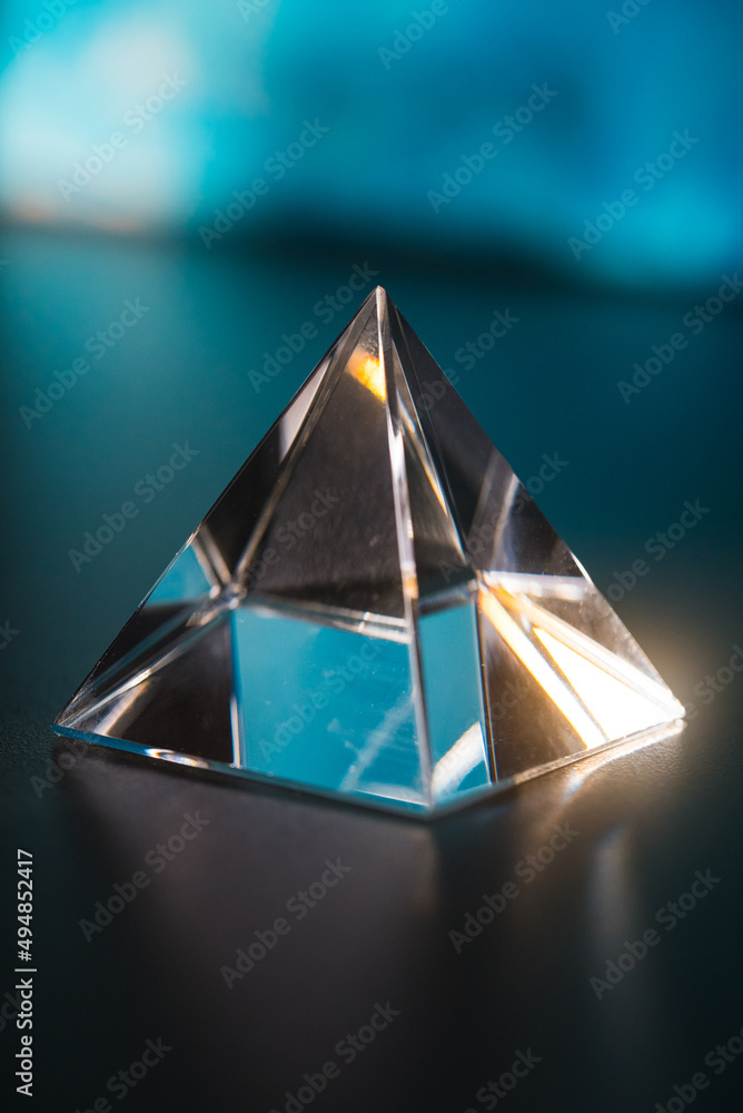 Transparent triangular prism on the table. Prism for design. Prism in ...