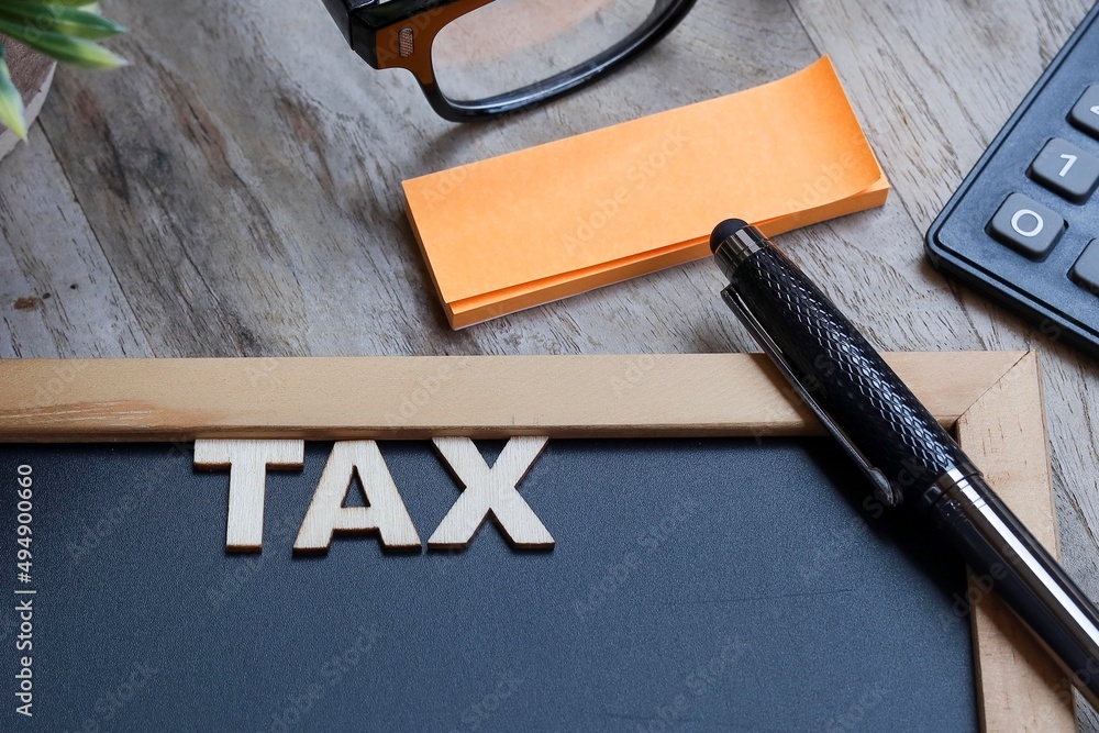 Business and tax concept. Close-up view on the TAX letterings on the ...