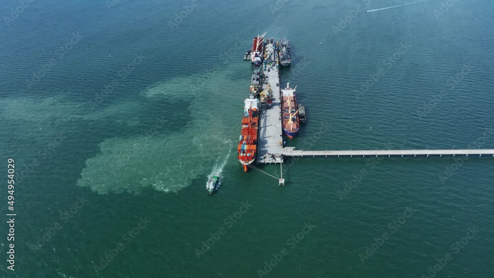 Aerial view of cargo container ship was drag by tug boat to ...