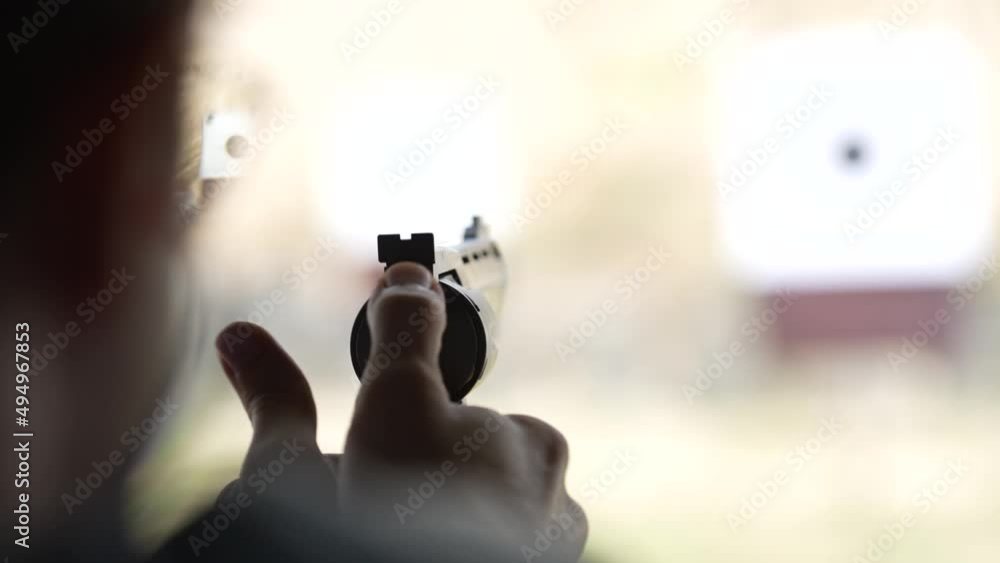Man shoots with a revolver at targets on the shooting range, close up ...