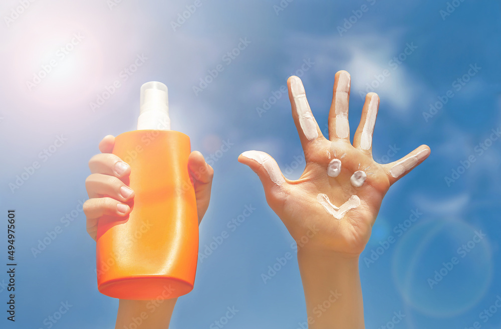 Two caucasian hands on blue sky, clouds and beams of sun background ...