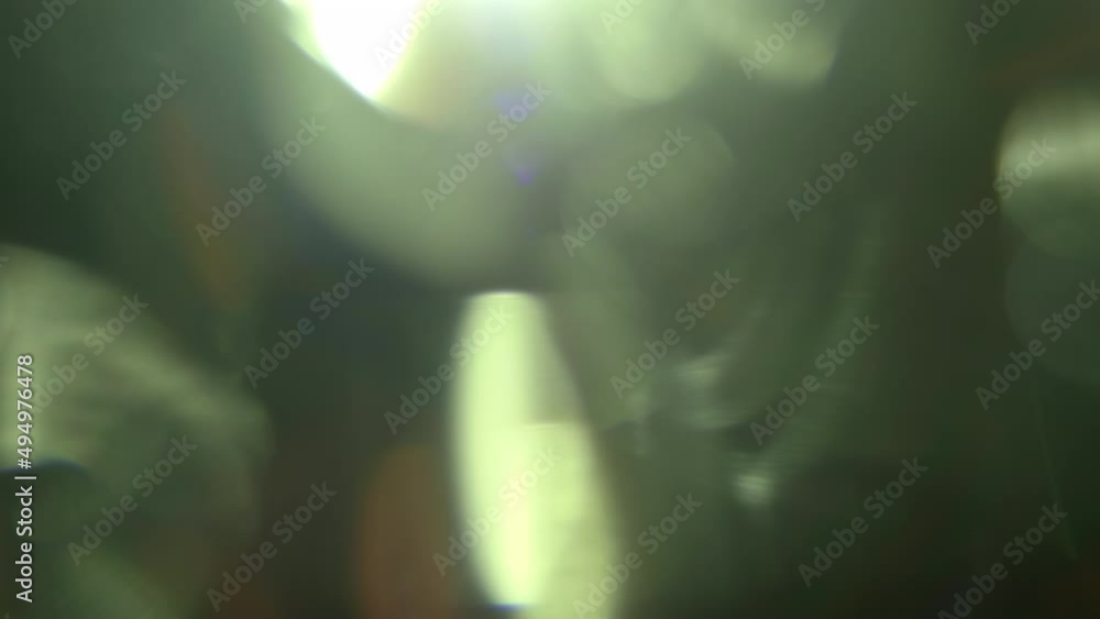 Lens flare overlay asset in front of a black background. Real light ...