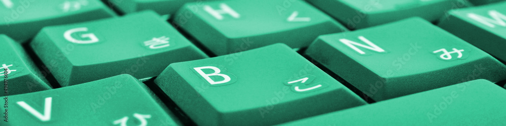 Japanese typing. Light green laptop keyboard closeup. Symbols on the ...
