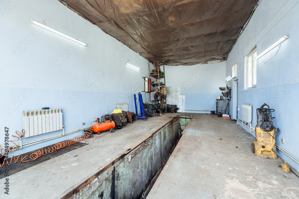 large long garage with a pit Stock Photo | Adobe Stock