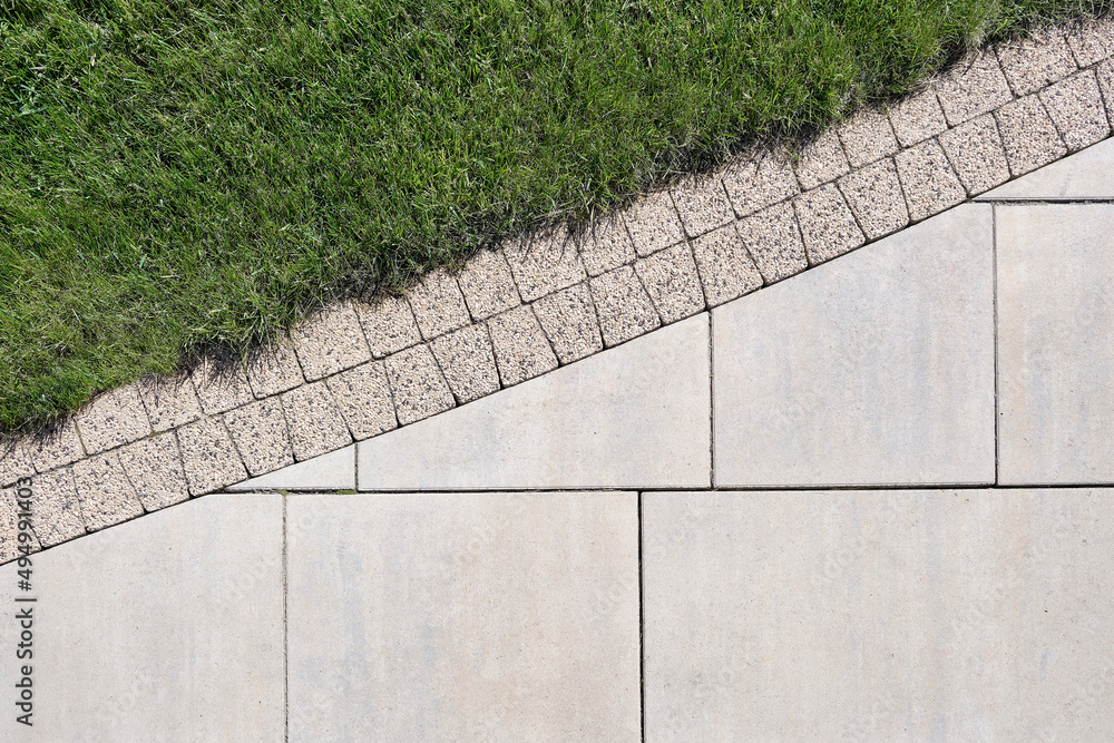 Combination of сoncrete slabs and paving tiles on the border with a ...