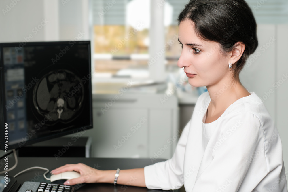 Radiologist woman reading a CT scan. Female doctor running CT scan from ...
