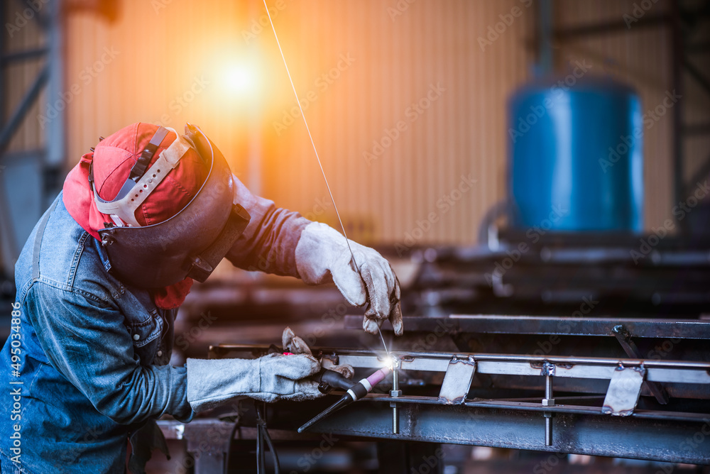 Industrial welder welding fabricated stainless construction work in ...