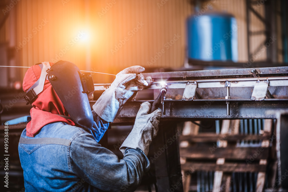 Industrial welder welding fabricated stainless construction work in ...