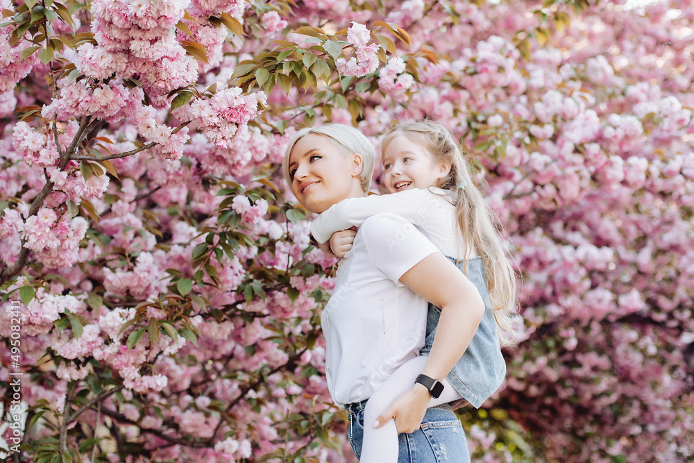 People, holidays and family concept - daughter hugs mom sitting on her ...
