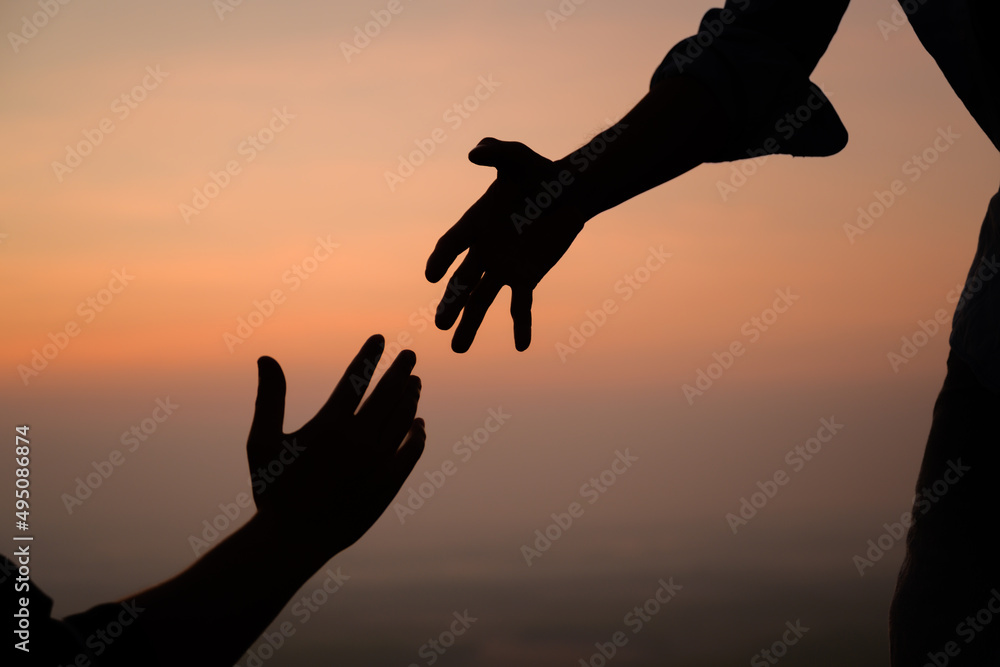 two people silhouettes about reaching out to help each other concept ...