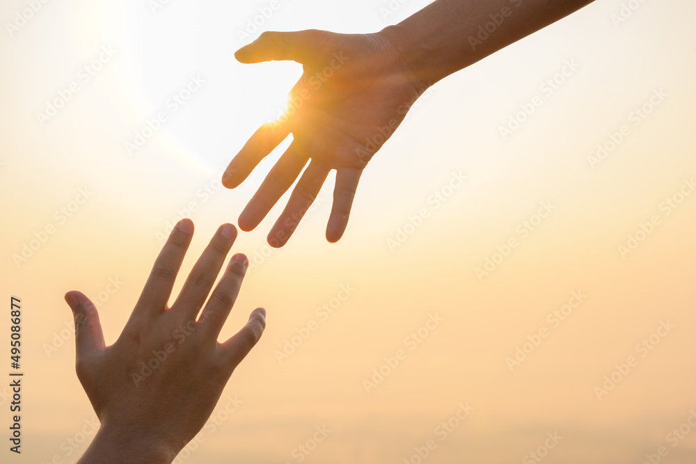 two people holding hands The concept of shaking hands to help the ...
