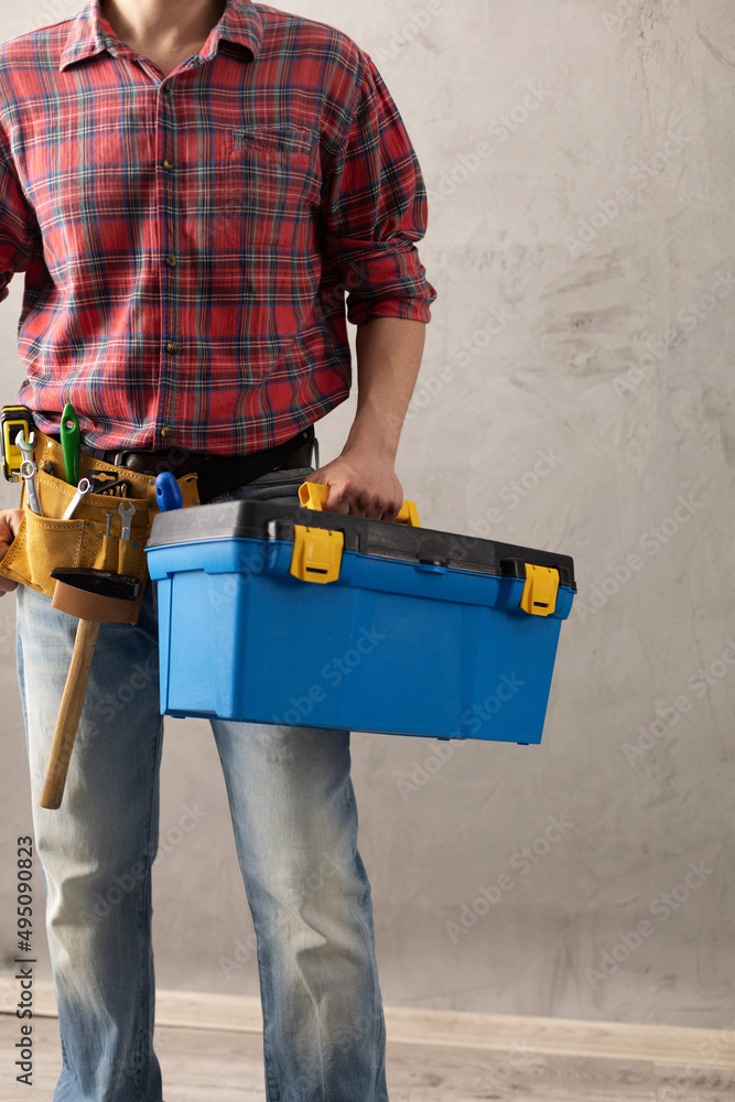 Worker man holding construction tool box in house room renovation. Male ...