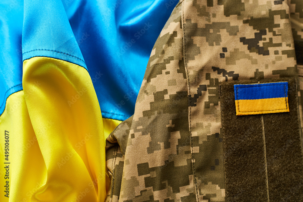 Ukraine flag and military uniform of ukrainian soldier. Armed Forces of ...