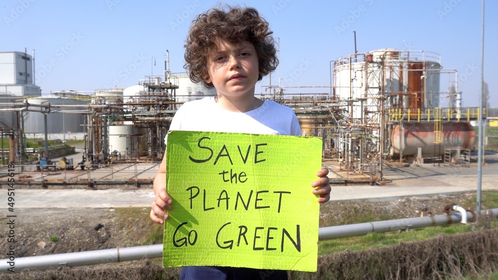 7-year-old boy protests with the inscription Save the Planet go green ...