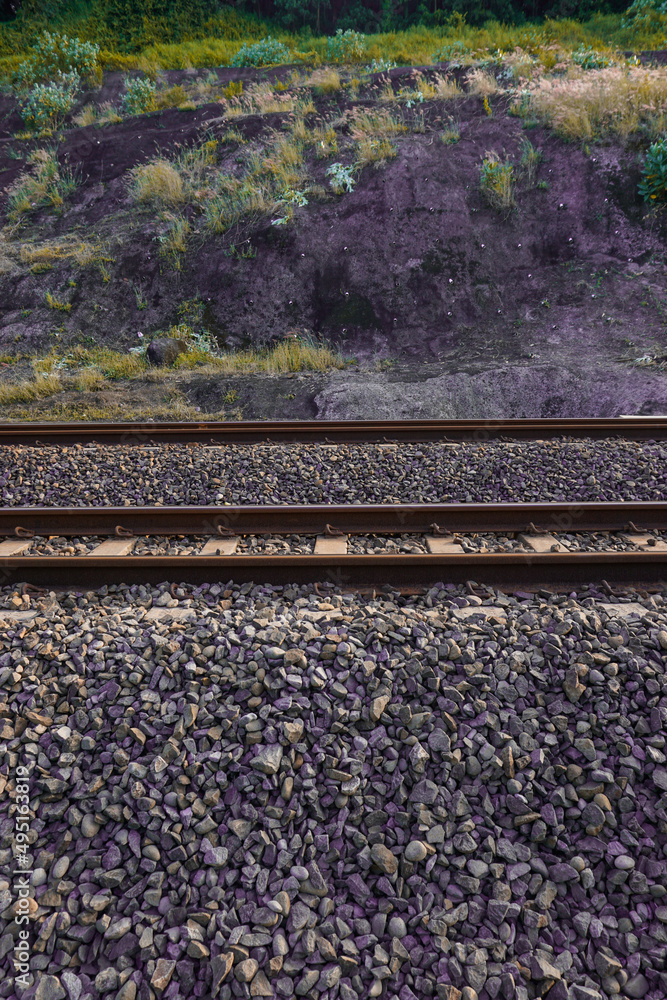 The railroad tracks pass through the grooved bearings buried under the ...