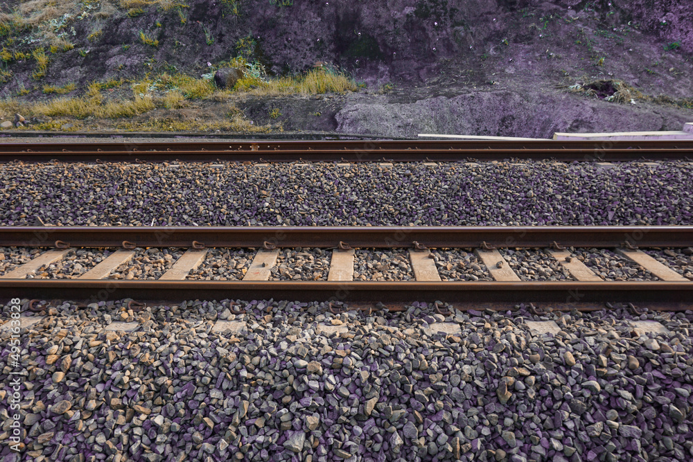 The railroad tracks pass through the grooved bearings buried under the ...