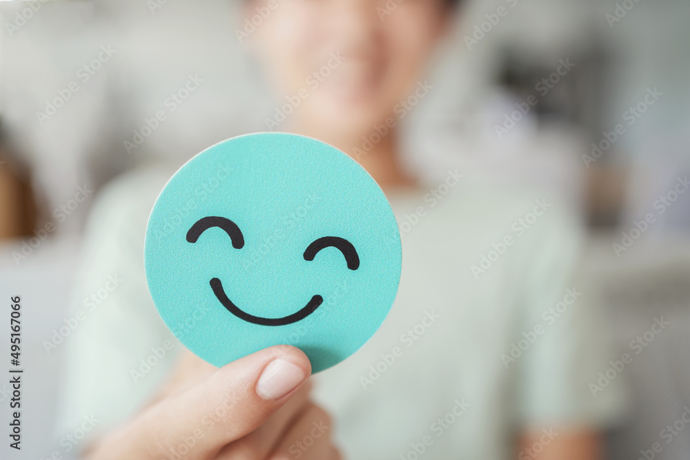 Hands holding green happy smile face paper cut, good feedback rating ...