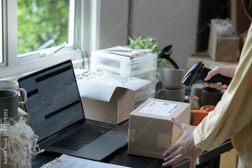 Hands scanning barcode on delivery parcel. Worker scan barcode of ...