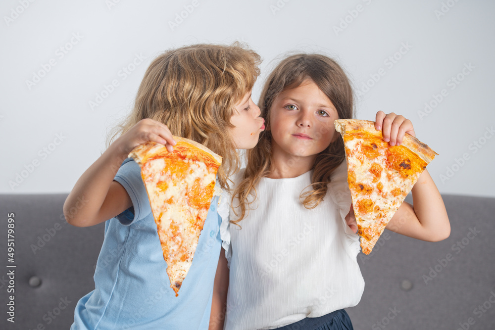 Hungry kids eating pizza. Happy children eating pizza and having fun ...