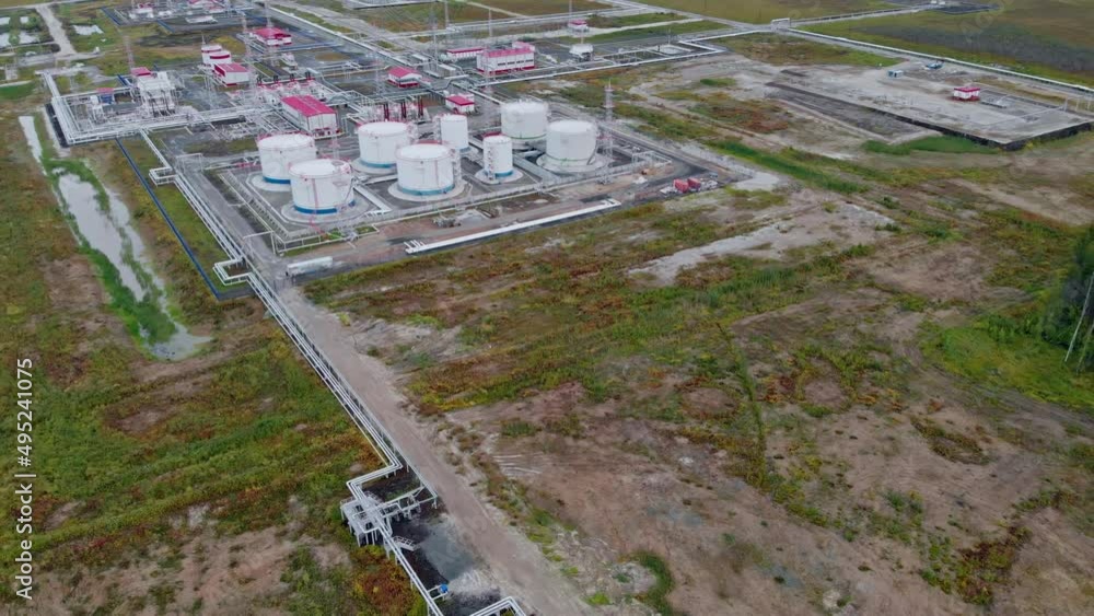 The drone flies over oil tanks at the oil field and primary processing ...