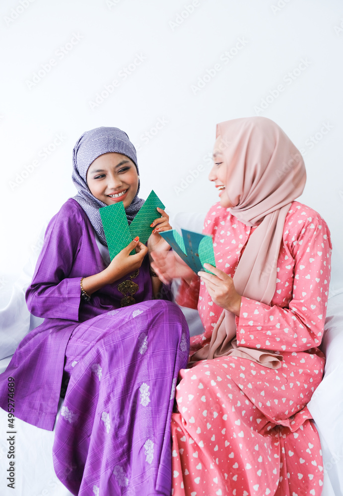 Selective focus and motion blur lady happy receive "duit raya envelope ...
